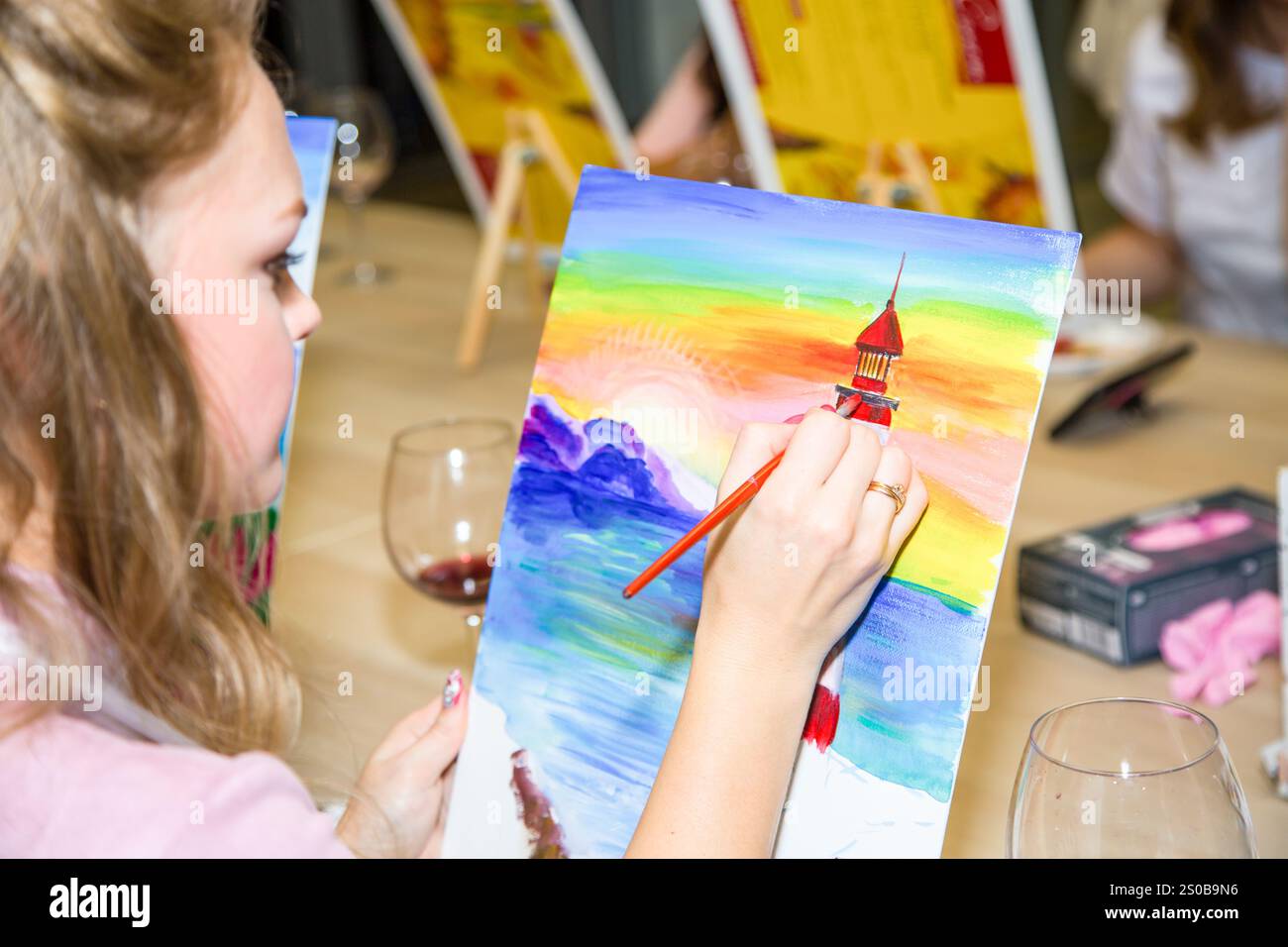 A group of Young individuals enjoying paint n sip activities outdoor ...