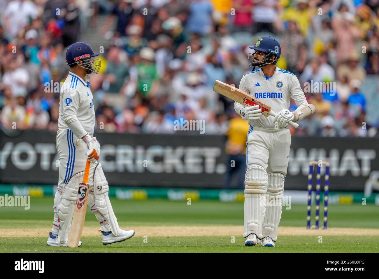 India's Akash Deep, right, walks off the field after losing his wicket ...