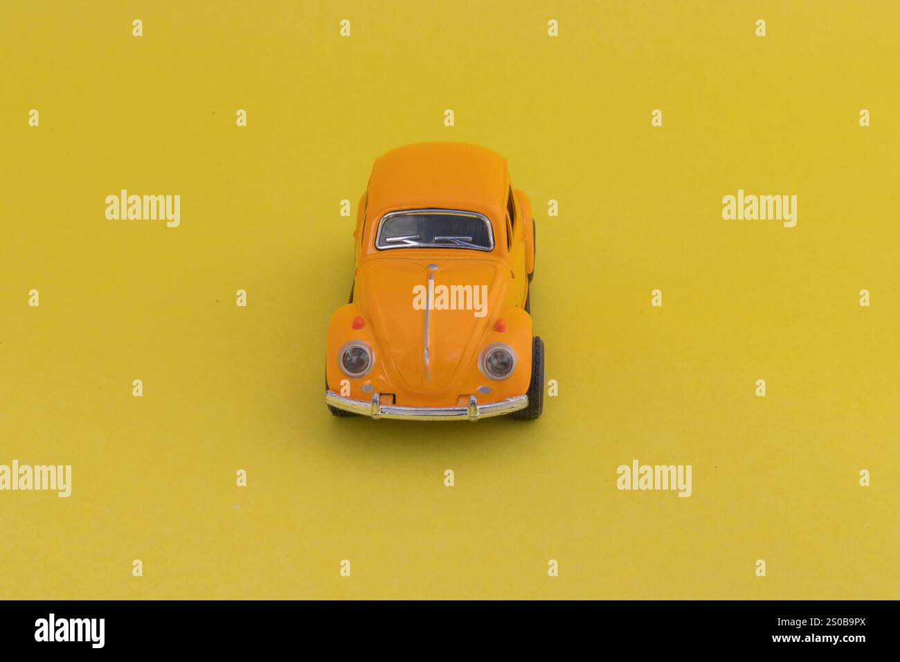 Front view of a yellow Volkswagen classic Beetle toy classic car model ...