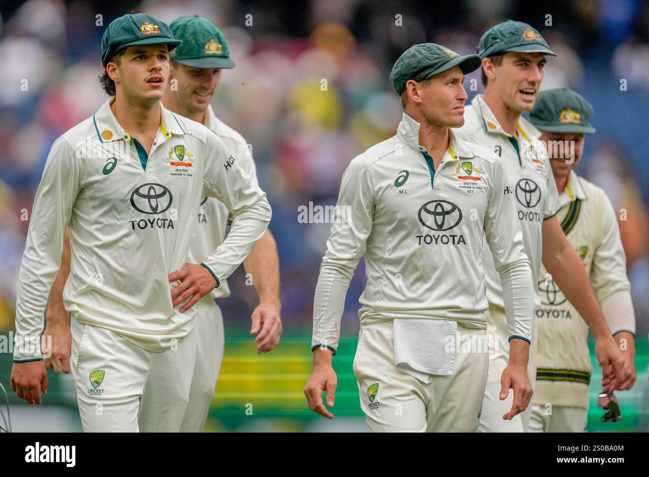 Australian players walk off the field on the end of play of the second ...