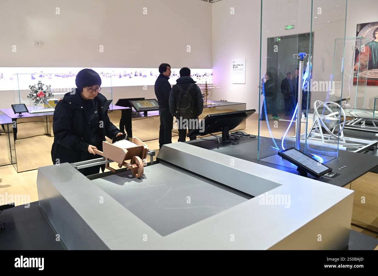 A visitor tries out a science and technology exhibit in the Hefei ...