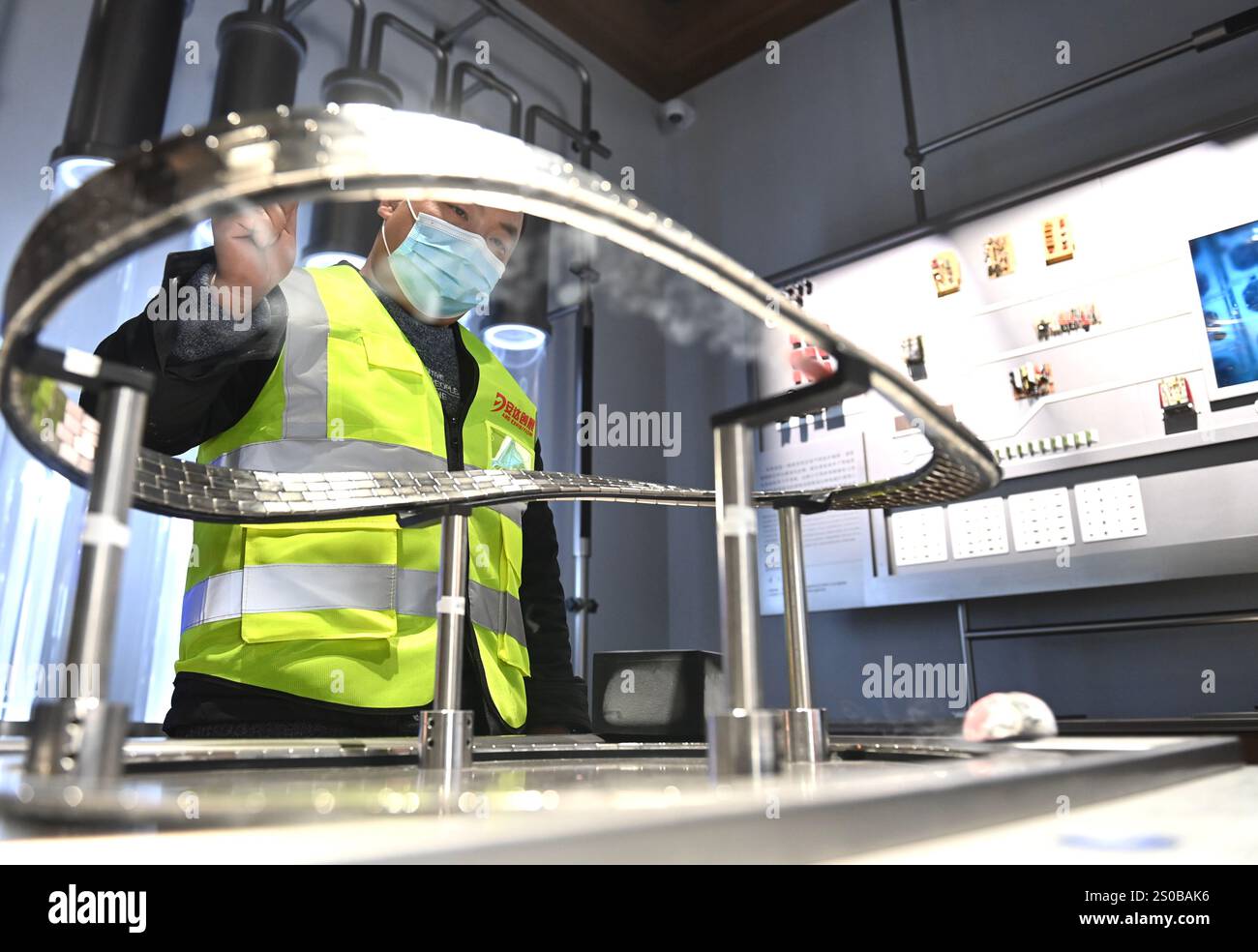 A staff showcases superconducting science experiment at the modern ...