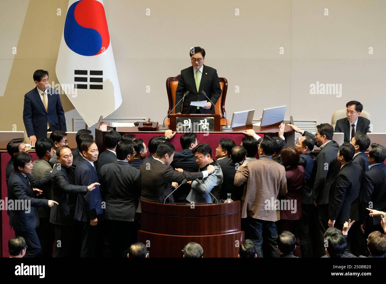 South Korea's National Assembly Speaker Woo Won Shik, top center ...