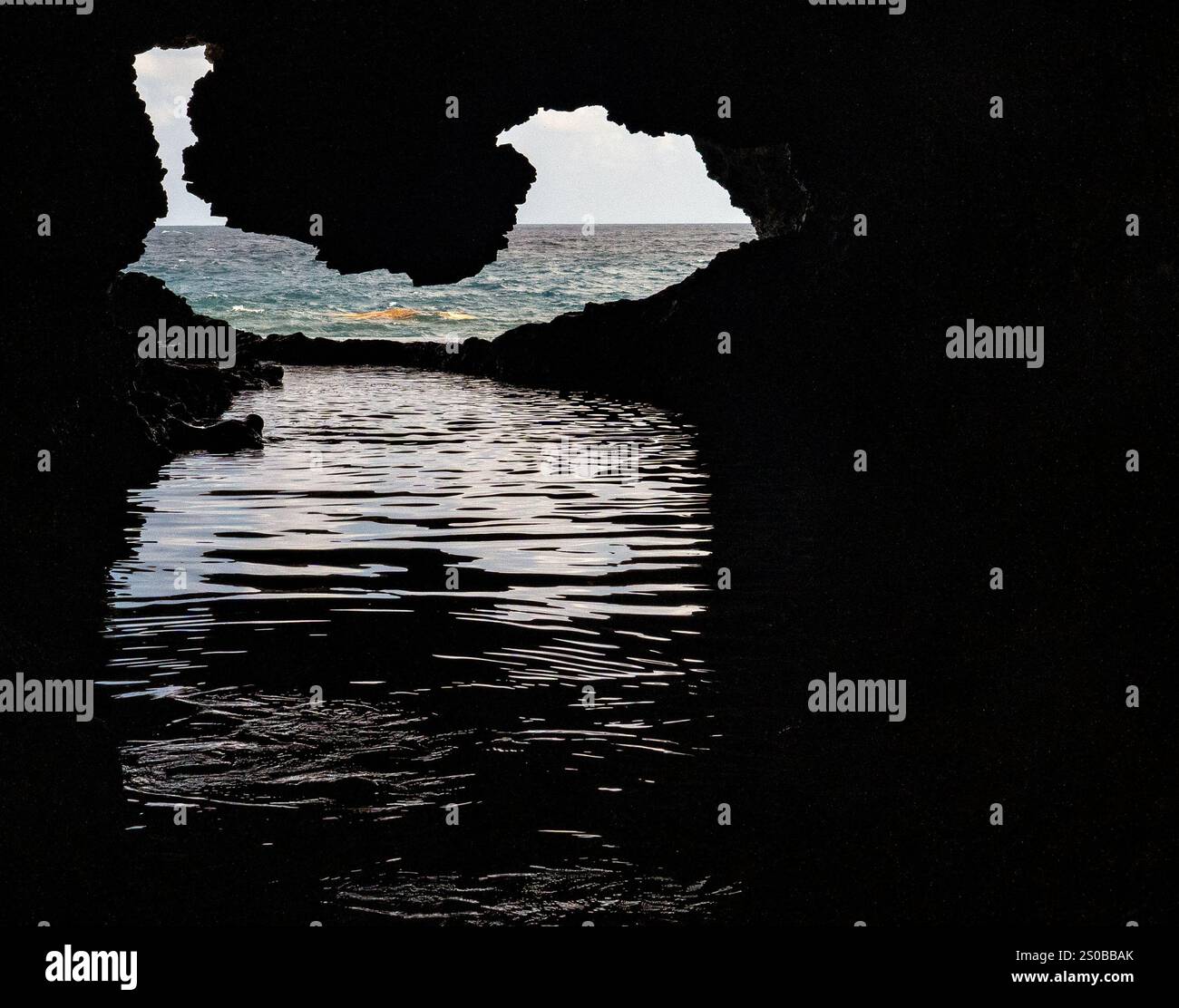 A view from inside a cave looking out towards the ocean. The cave ...