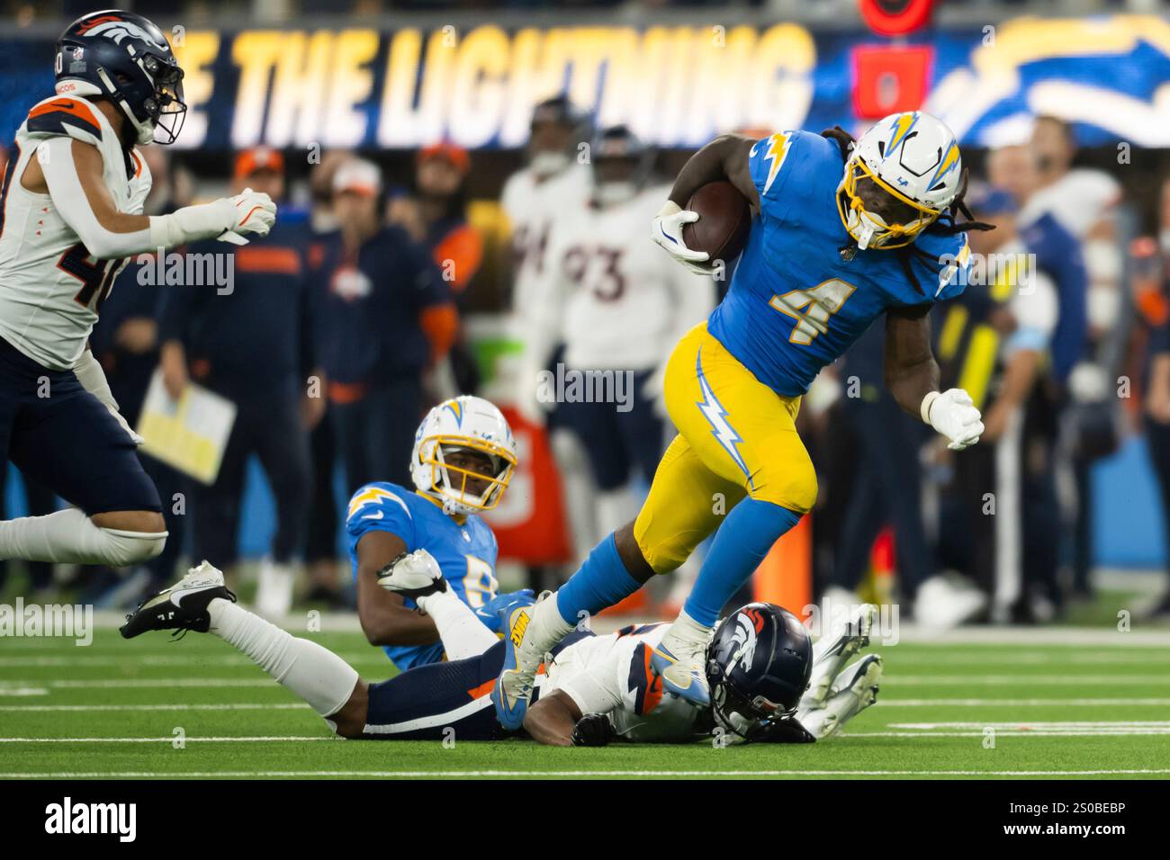 Los Angeles Chargers running back Gus Edwards (4) runs with the ball ...