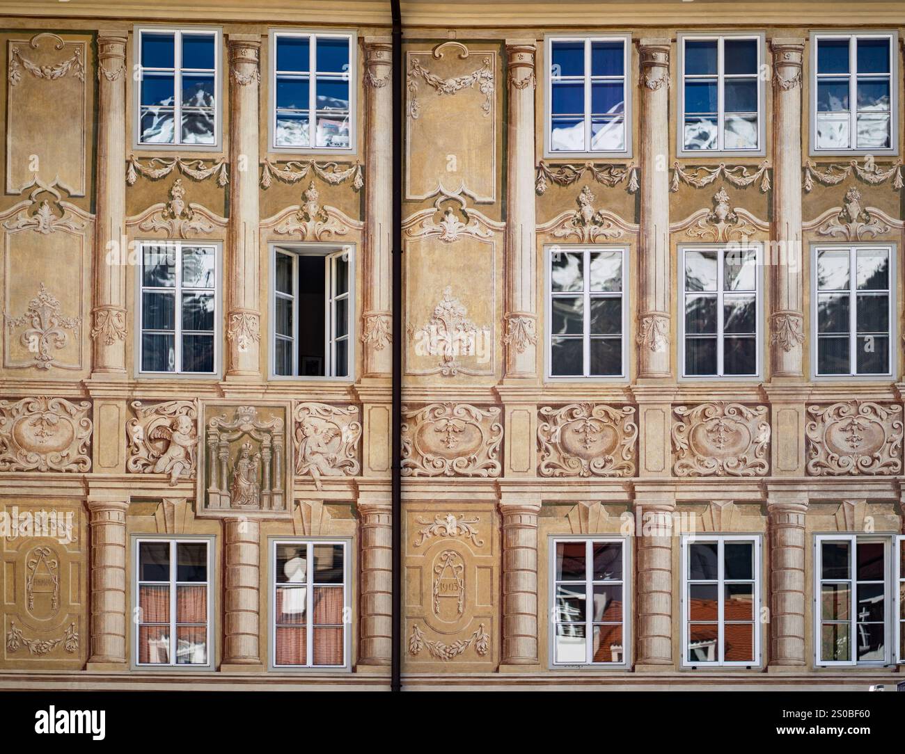 Ornate building facade with symmetrical windows and decorative stucco ...