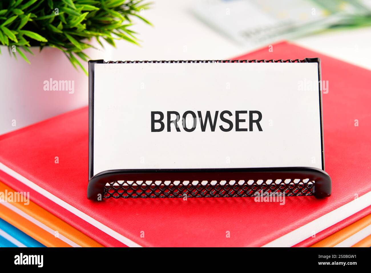 A black nameplate labeled Browser sits on a desk surrounded by neatly ...