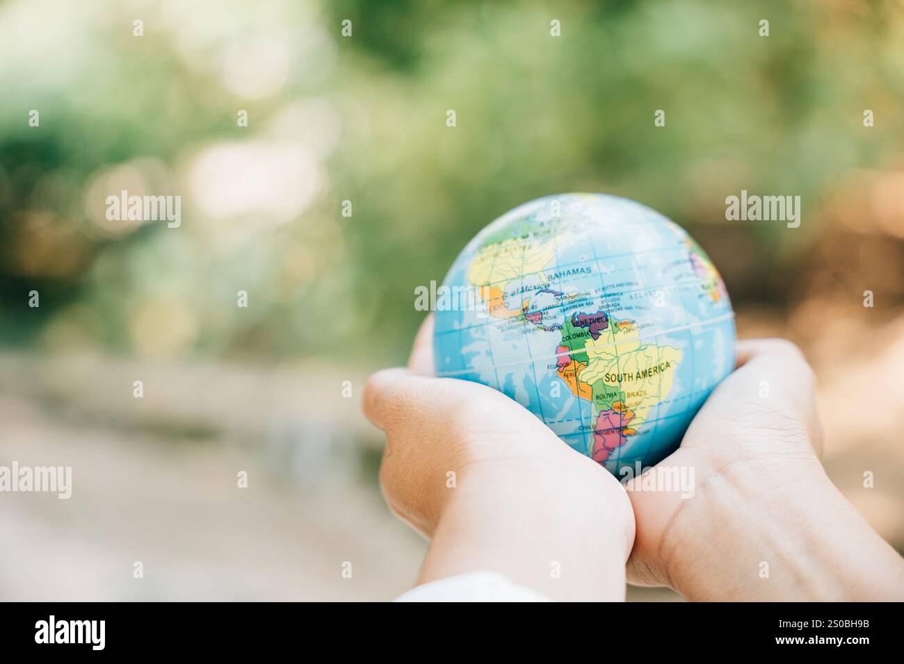 Embrace the Green Planet in your hands, signifying Earth's preservation ...