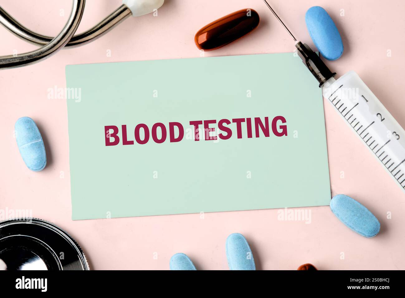 A card labeled blood testing is surrounded by medical tools, pills, and ...