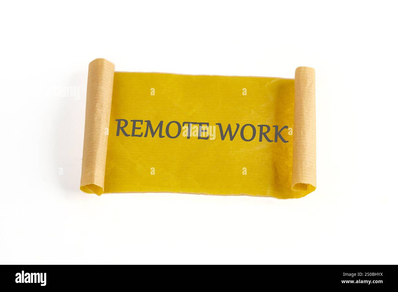 A yellow scroll unrolled on a white surface features the words remote ...