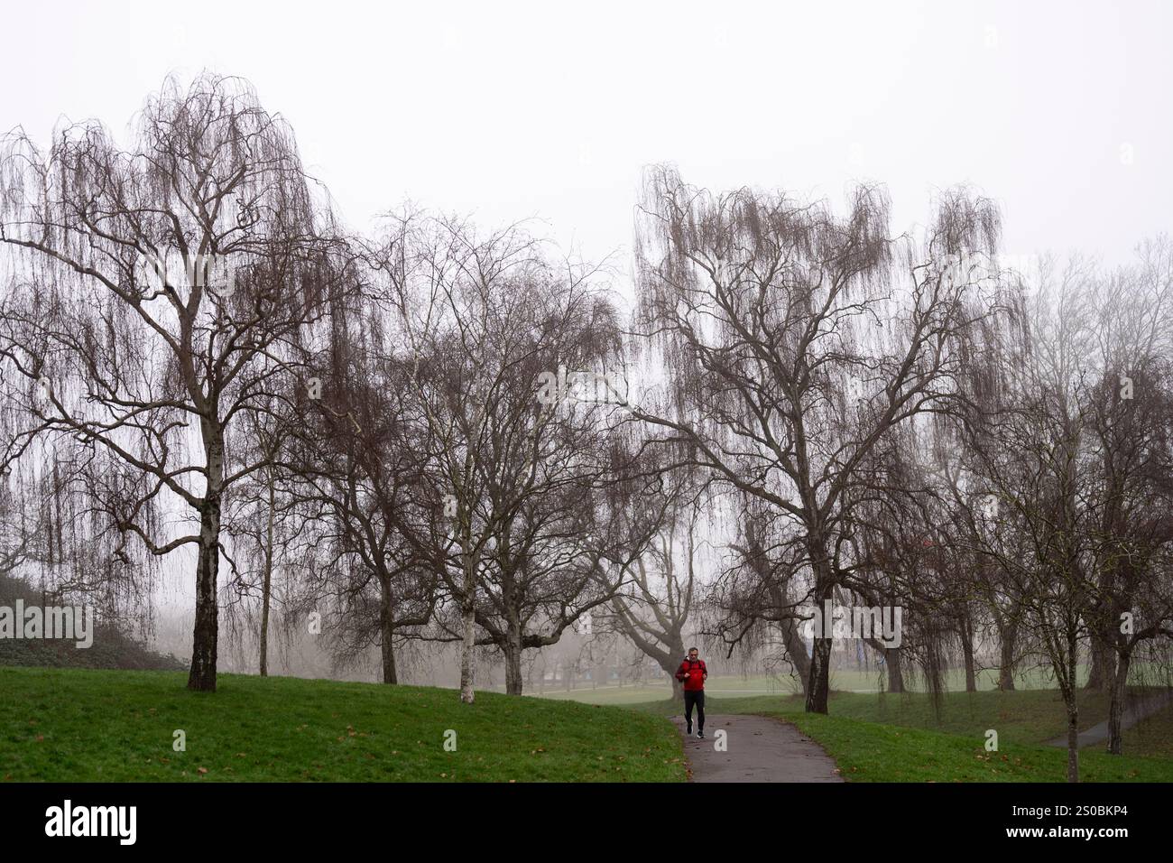 A jogger in foggy weather in Greenwich Park in London. The UK will have ...