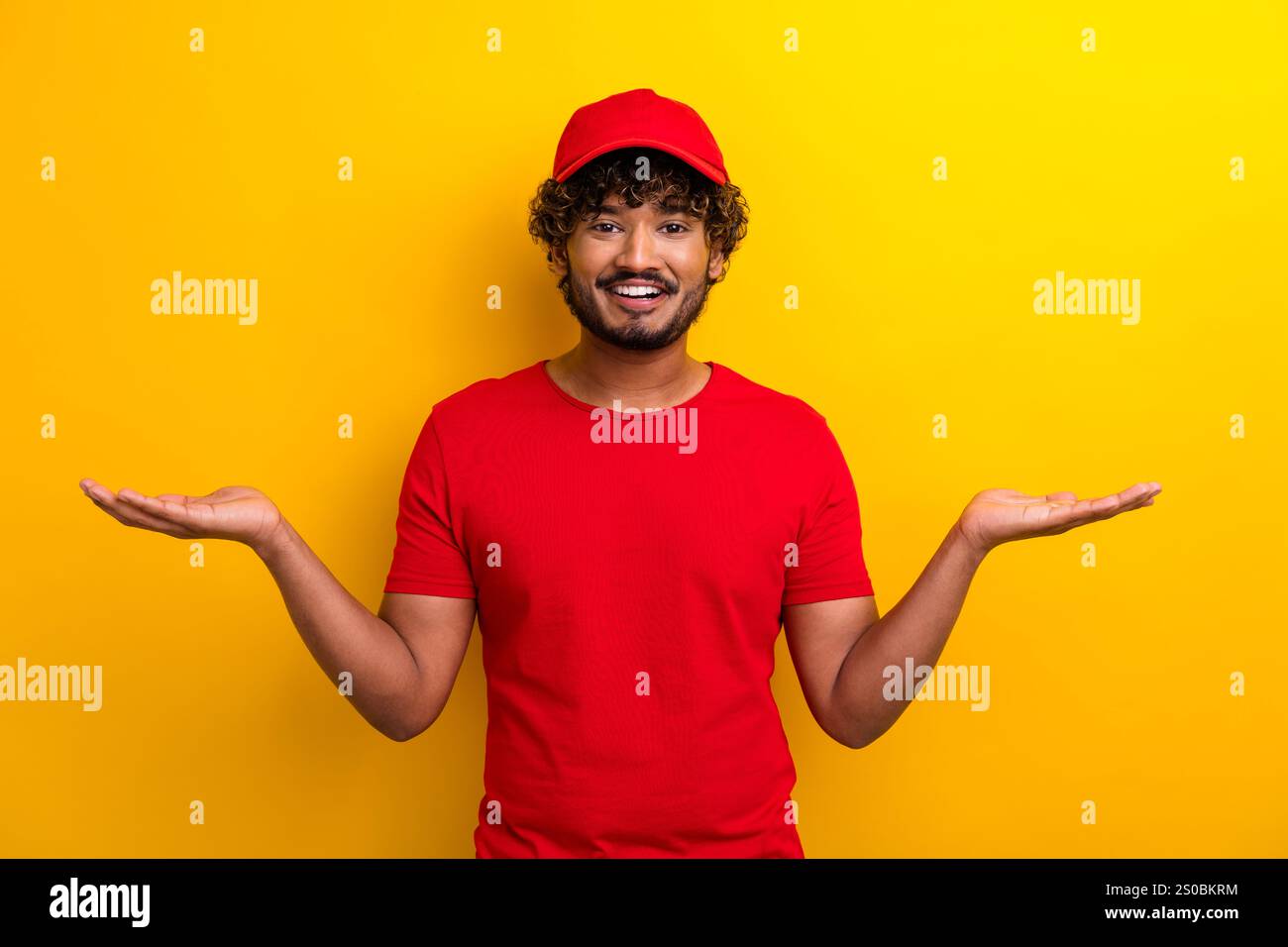 Confident Young Man in Red Attire Posing Against a Vibrant Yellow ...