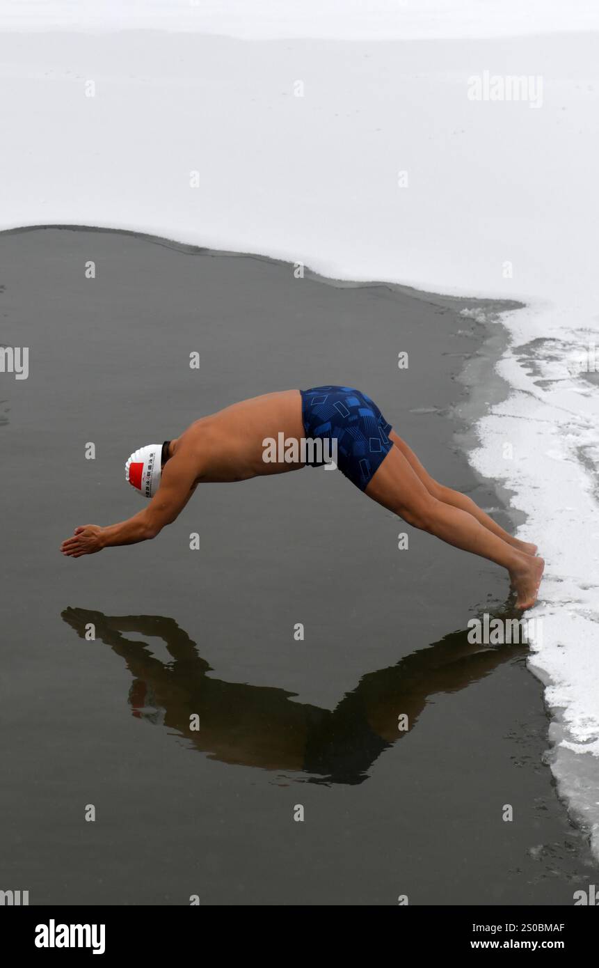 Winter swimming enthusiasts swim in the icy water in Korla City ...