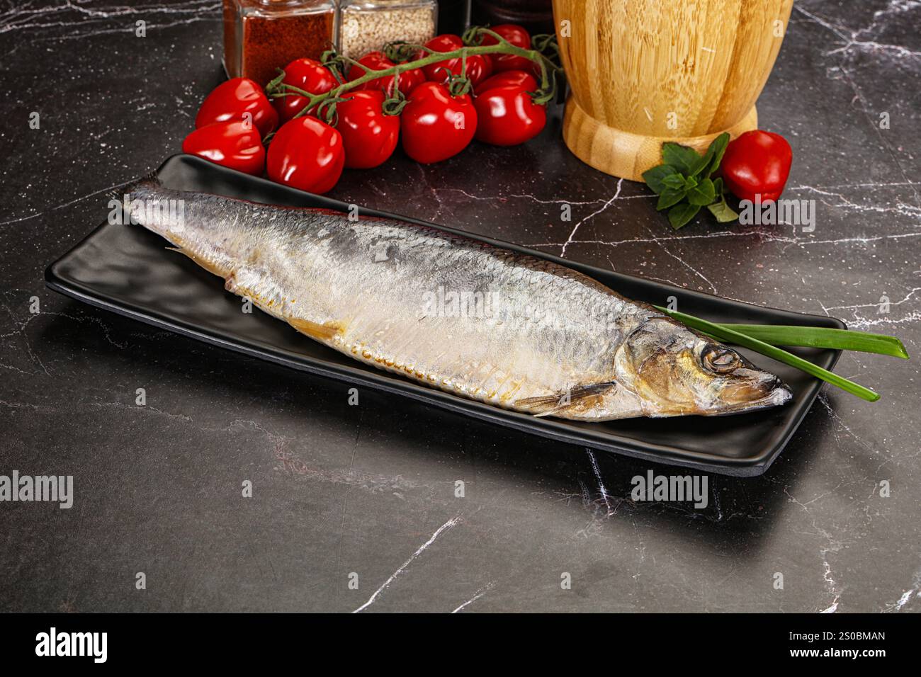 Whole raw salted herring fish in the plate Stock Photo - Alamy