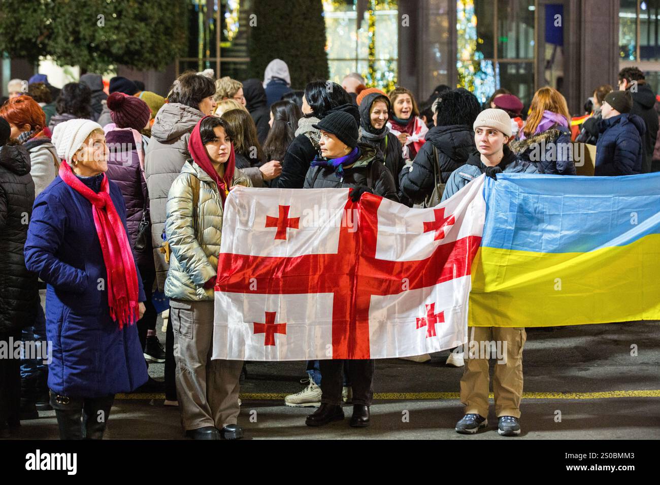 Tbilisi, Georgia. 26th Dec, 2024. Protesters march with flags during ...