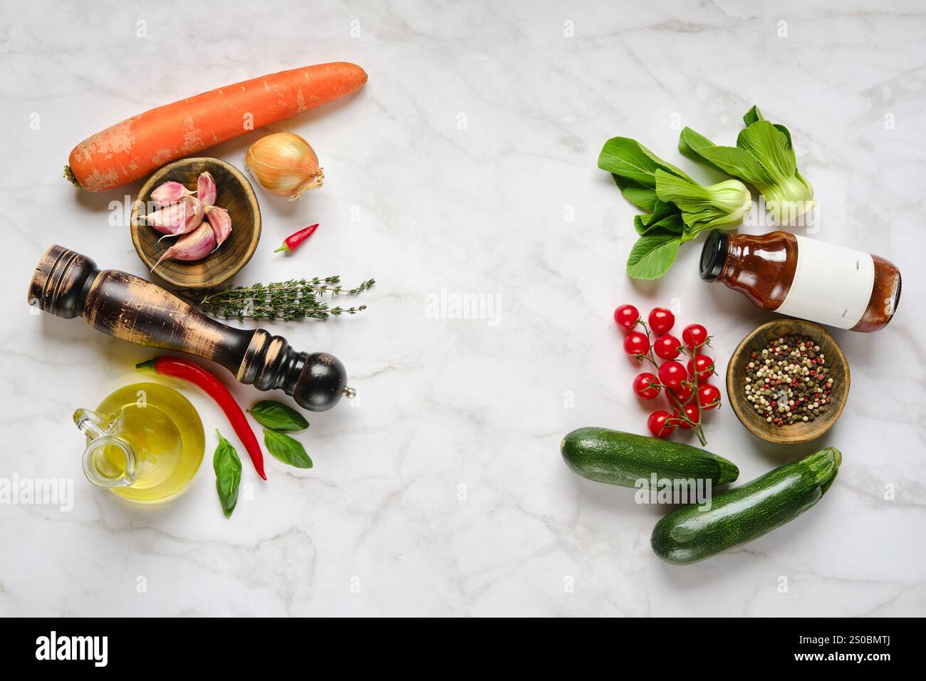 A variety of fresh vegetables, herbs, and condiments are beautifully ...