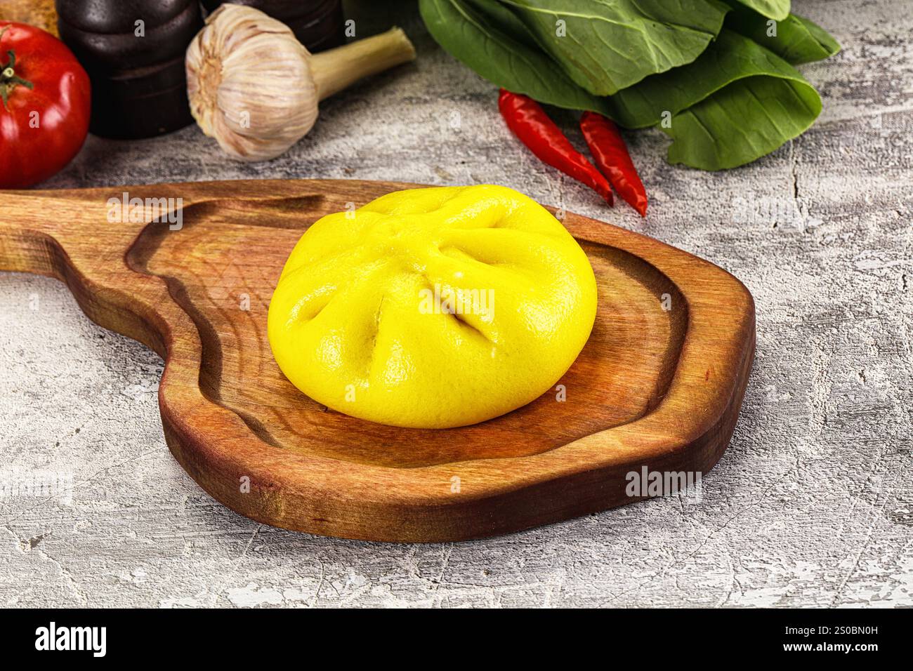 Asian stuffed steamed yellow Bun Bao Stock Photo - Alamy