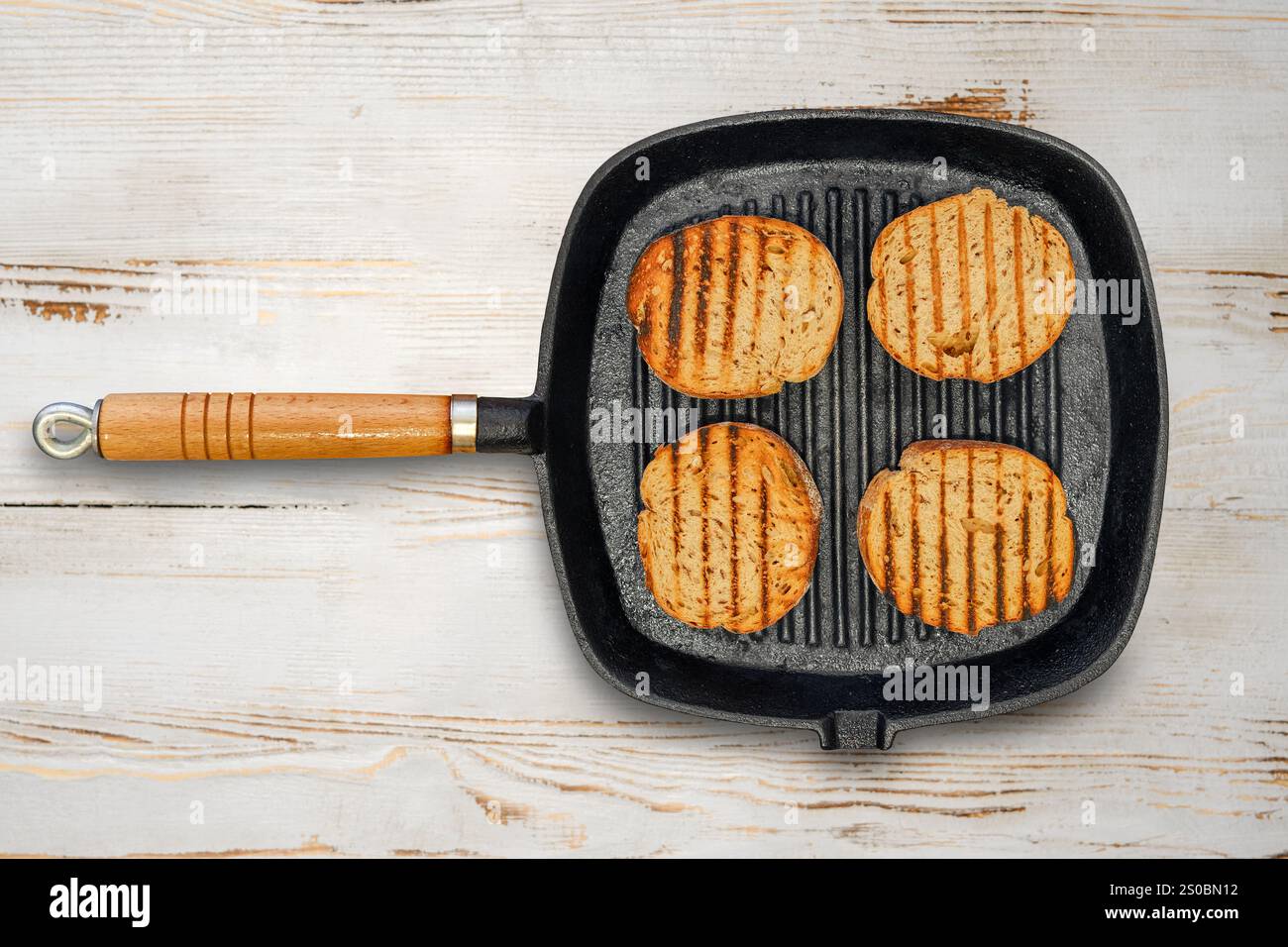 Four slices of toasted breadin a griddle pan on a stovetop, showcasing ...