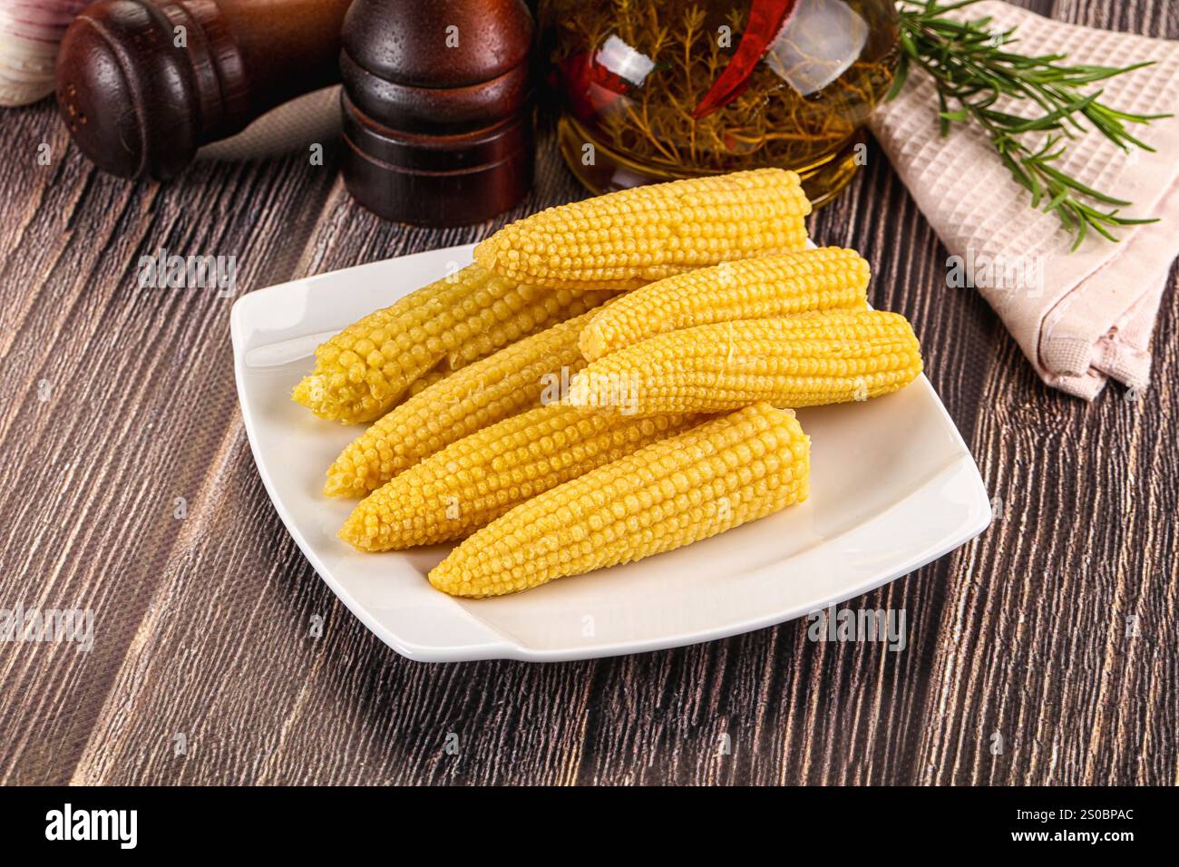Canned baby mini corn cob in the plate Stock Photo - Alamy