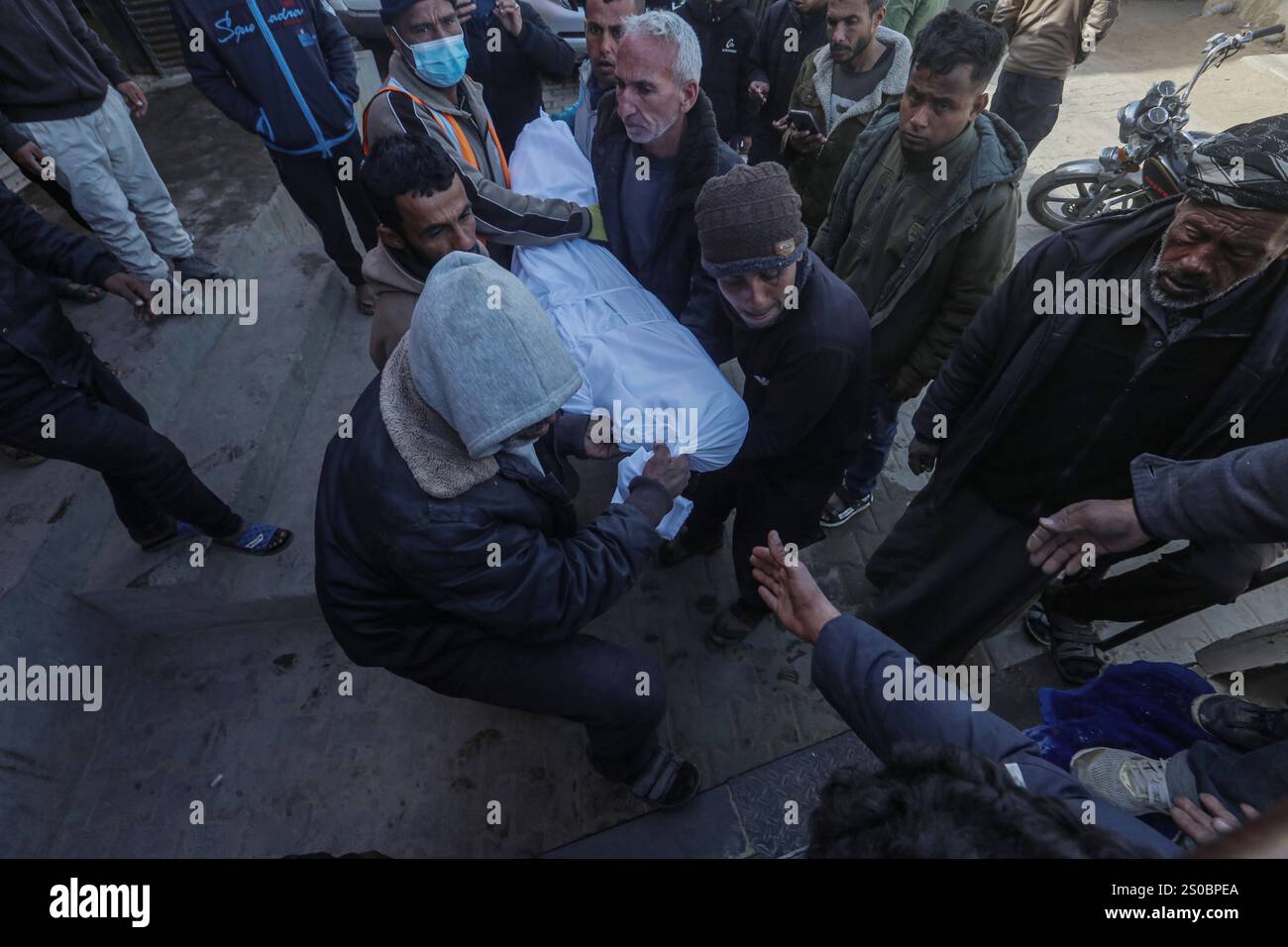 Relatives of the Palestinians died in Israeli attacks, mourn as they ...