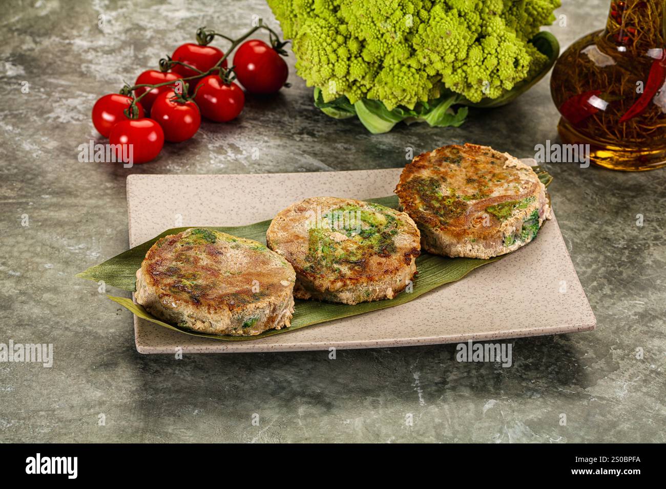 Roasted tuna medallion with broccoli cabbage Stock Photo - Alamy