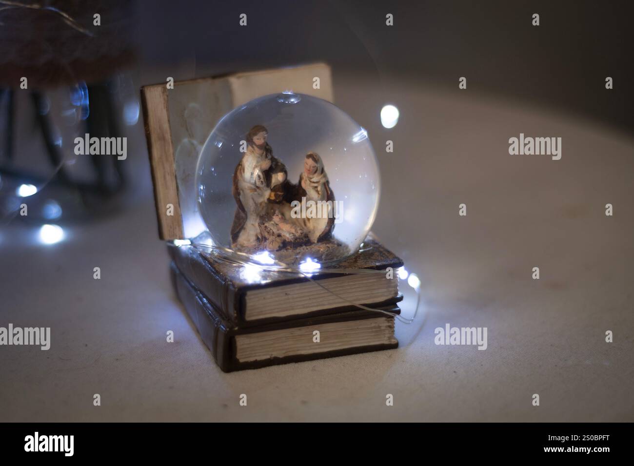 A delicate glass ball featuring a miniature nativity scene with Mary ...