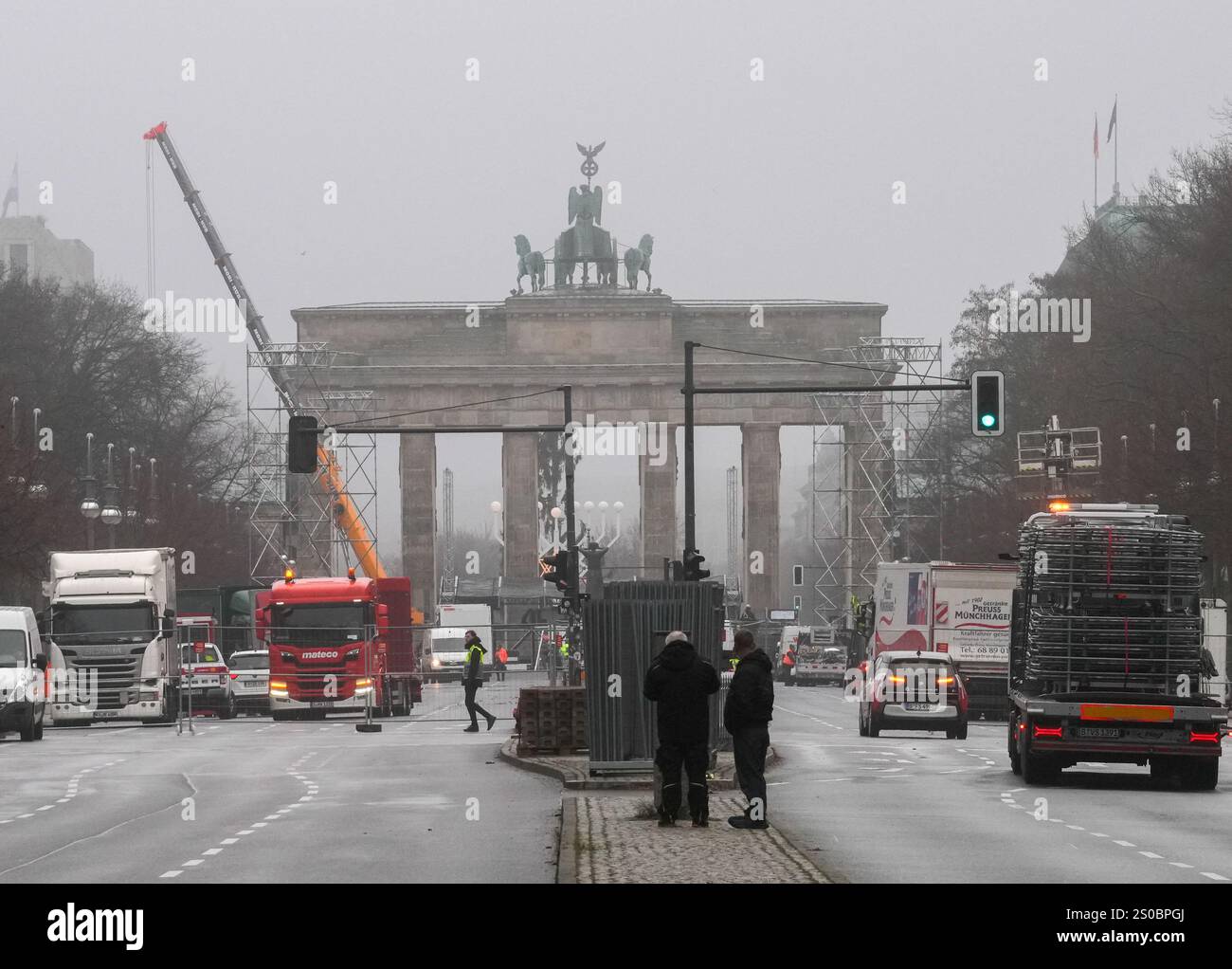 Berlin, Germany. 27th Dec, 2024. Trucks transport material and barriers ...