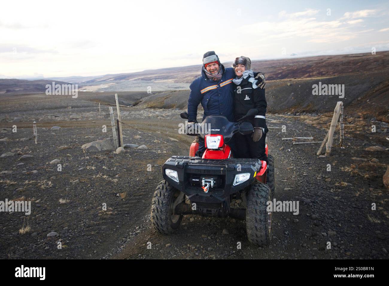 A couple posing on an ATV Stock Photo - Alamy
