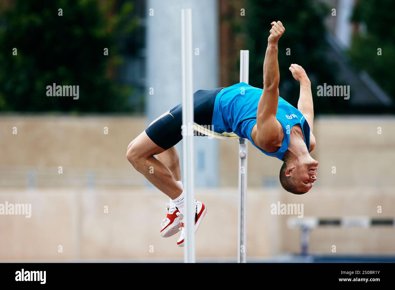 Athlete doing a high jump at Osterbro Stadium in Copenhagen Stock Photo ...