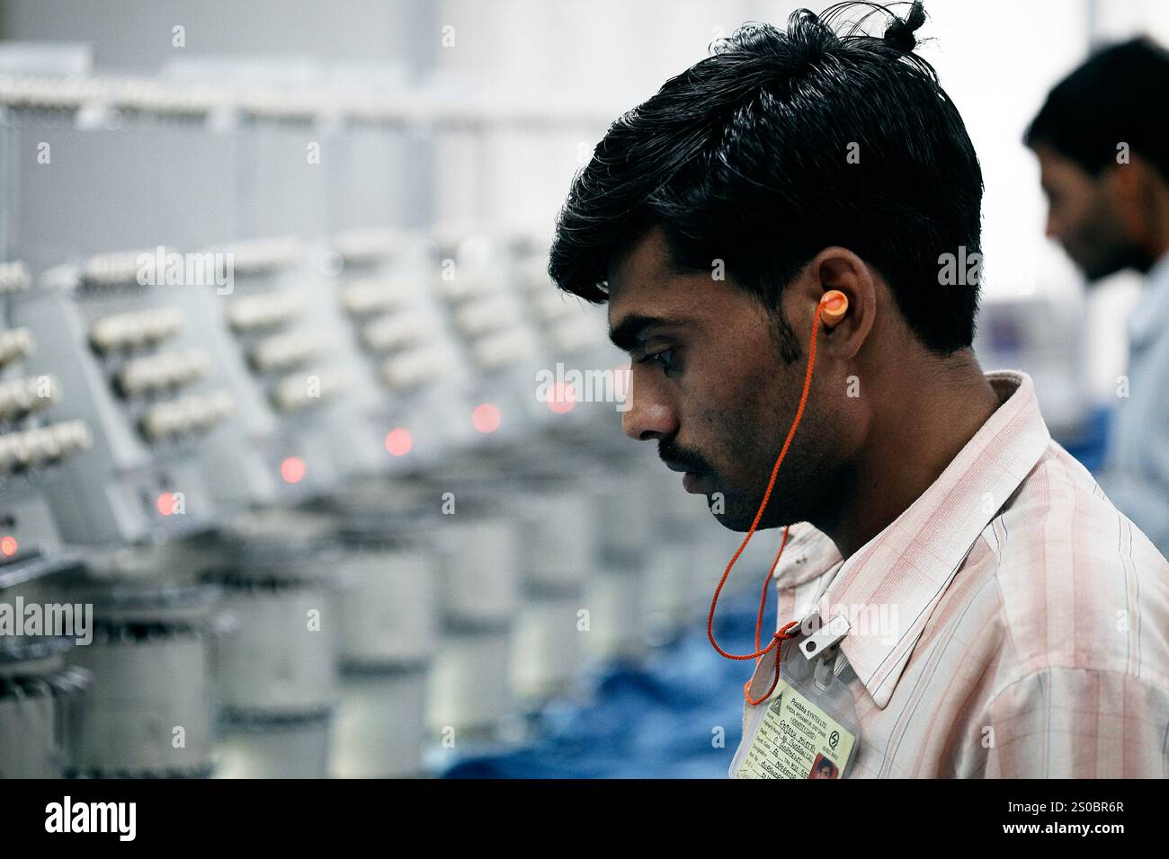 Indian factory worker with earplugs Stock Photo - Alamy