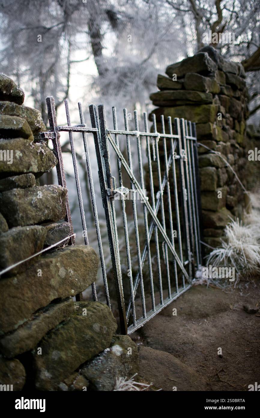 Heavey frost on metal gate between stone walls Stock Photo - Alamy