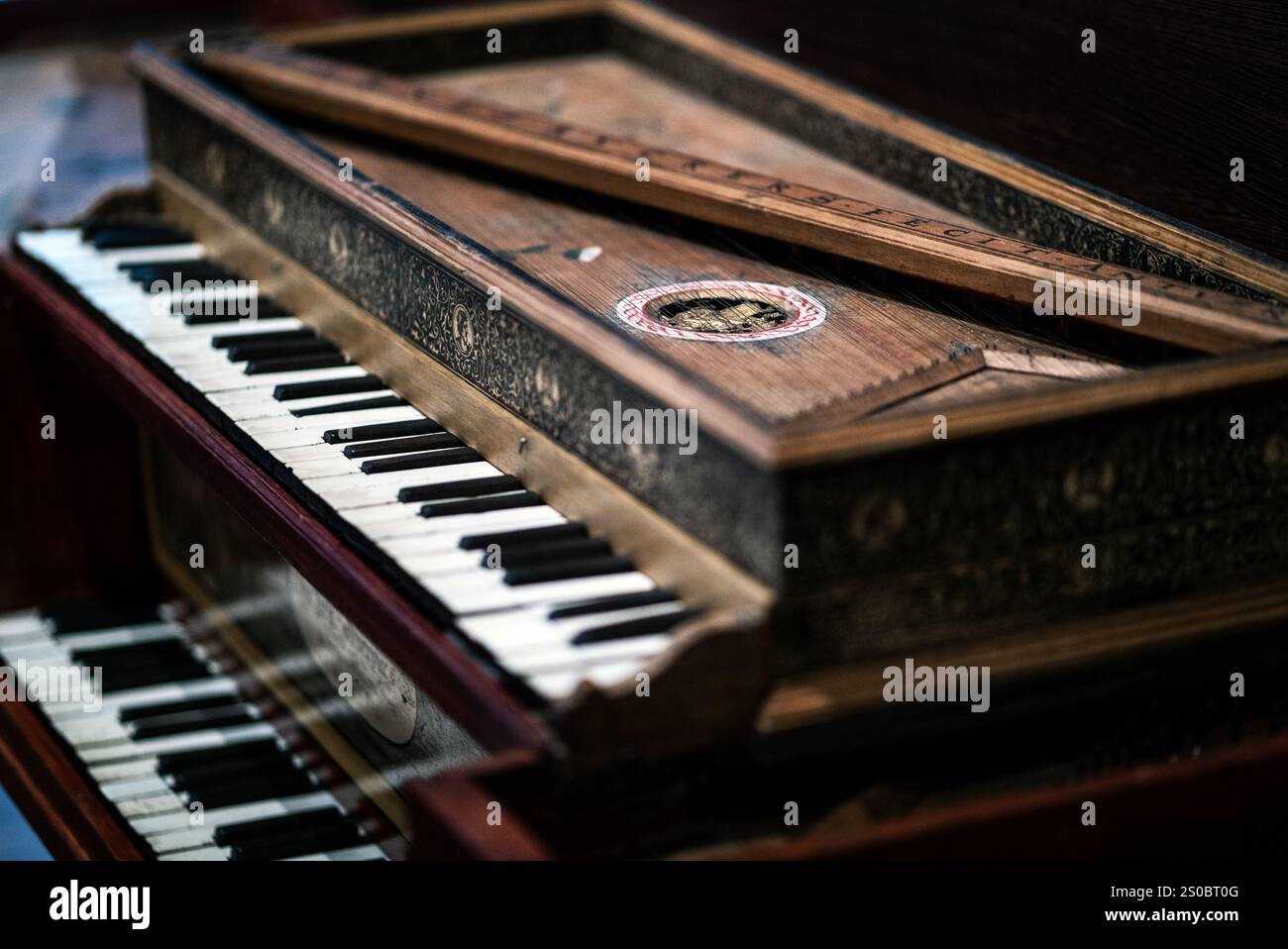 A close-up view of an antique piano, showcasing its intricate design ...