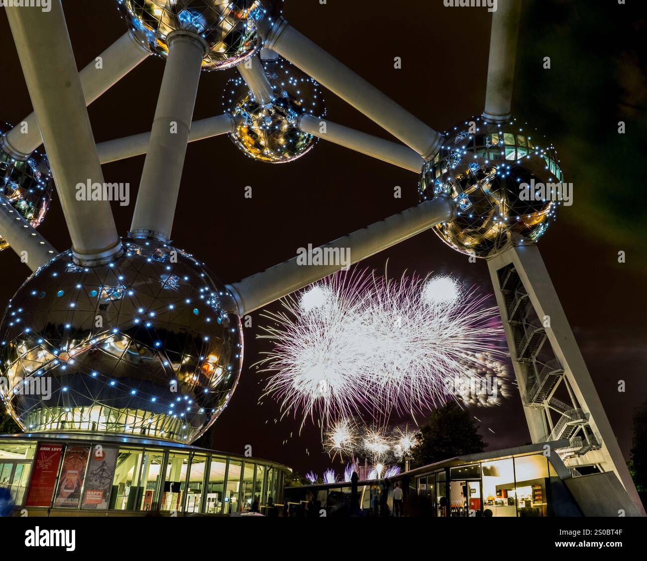 A stunning view of the Atomium in Brussels, illuminated at night with ...