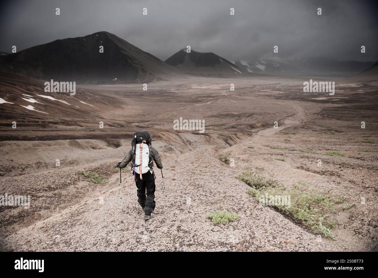 A mountaineer makes his way down to the base of mount Cerberus, Valley ...