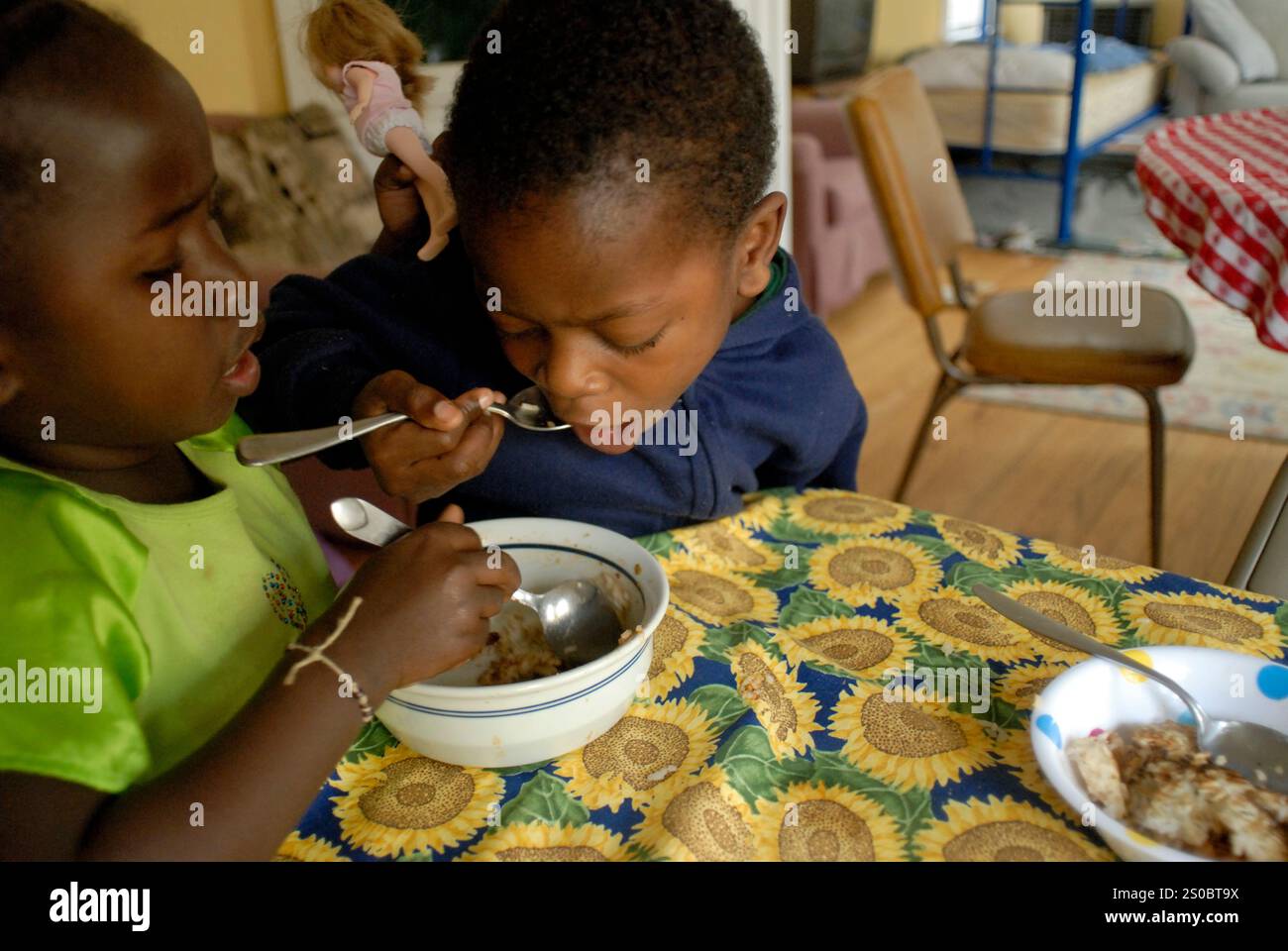 Everlyn and Pappay fight over the last bites of food at dinner Stock ...