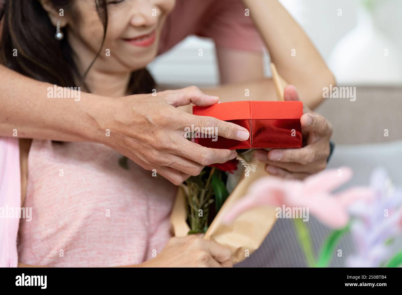 Romantic Valentine's Day Gift Exchange Between Couple with Red Gift Box ...