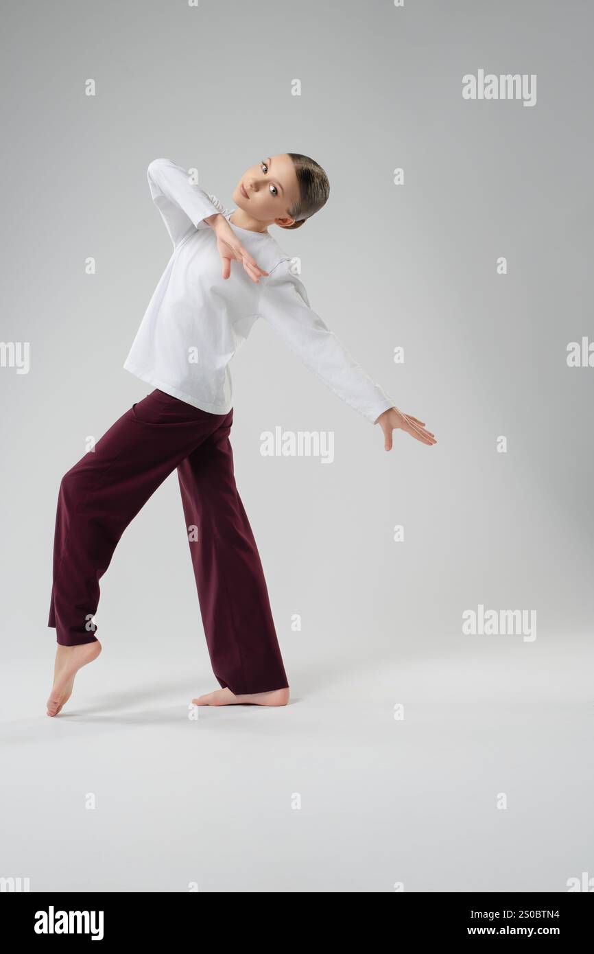 Girl performs an expressive dance routine in a modern art studio ...