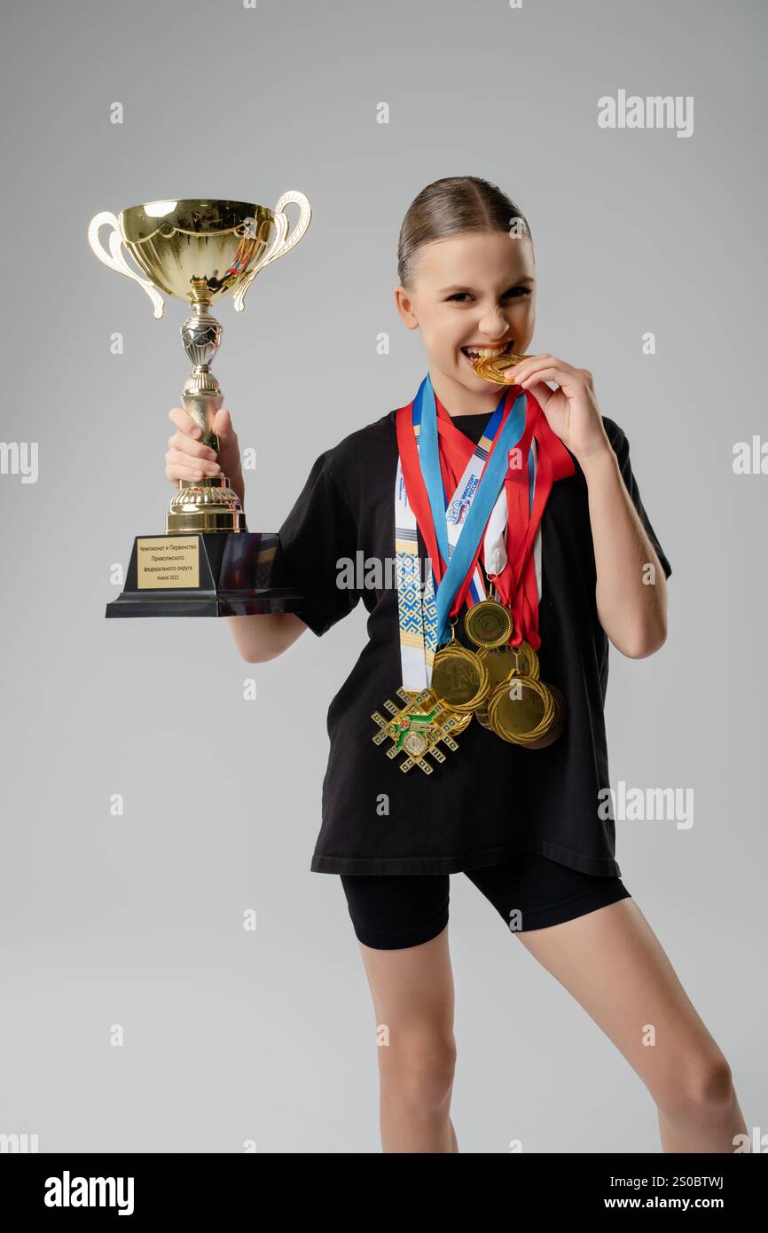 Champion dancer celebrates with trophy and medals after a successful ...