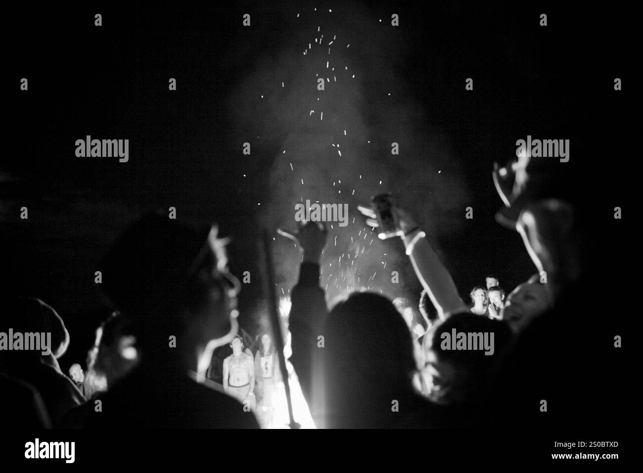 Hands around a bonfire at night Stock Photo - Alamy