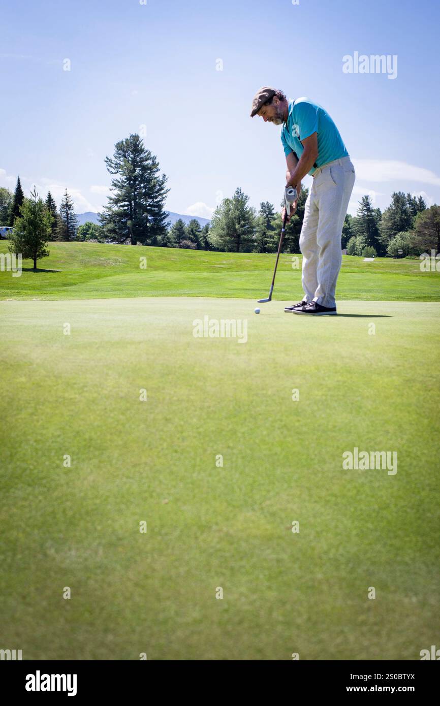 Middle Aged Man putts golf ball during Hickory Golf Tournament Stock ...