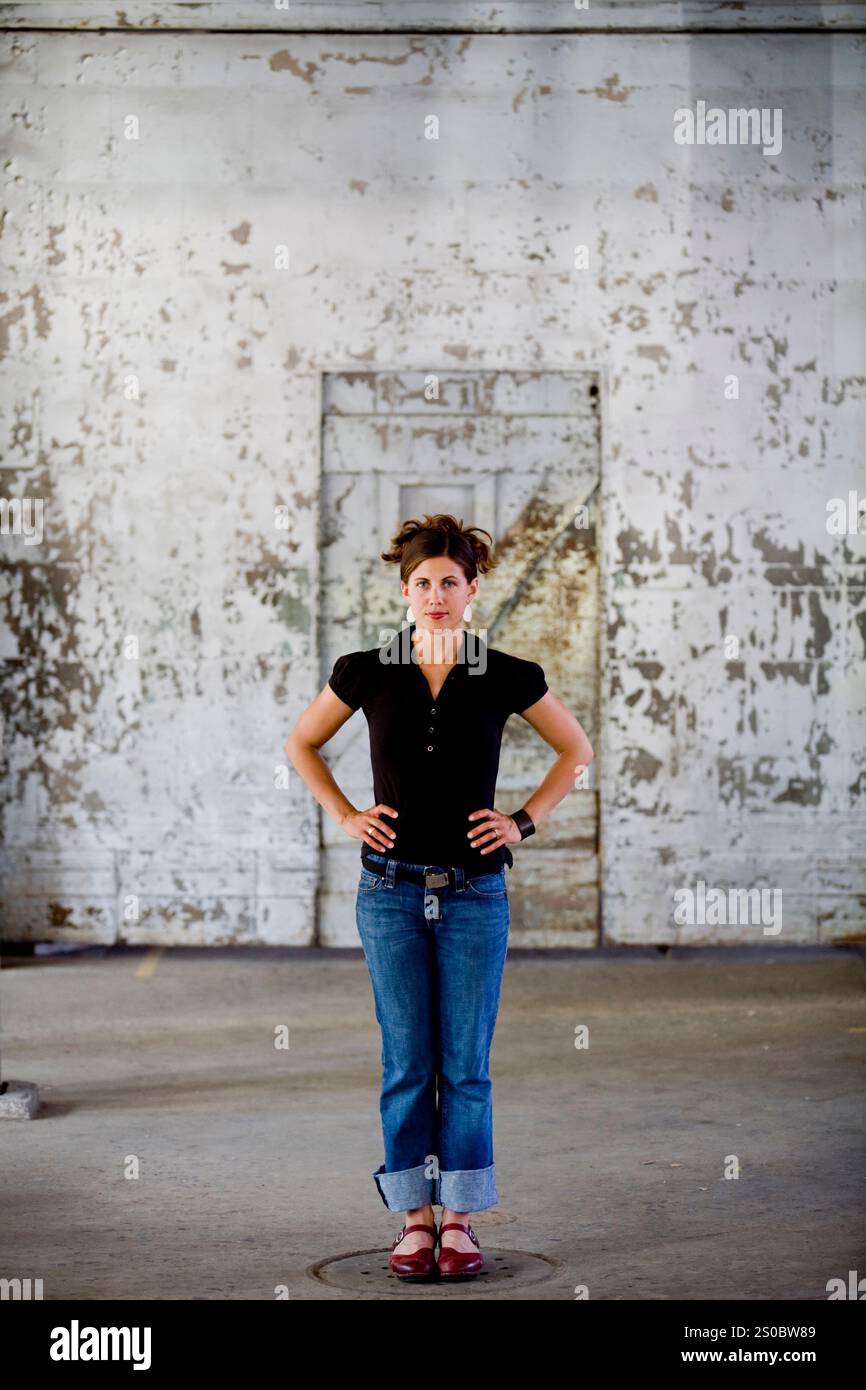 Young woman standing in front of a door with paint falling off Stock ...
