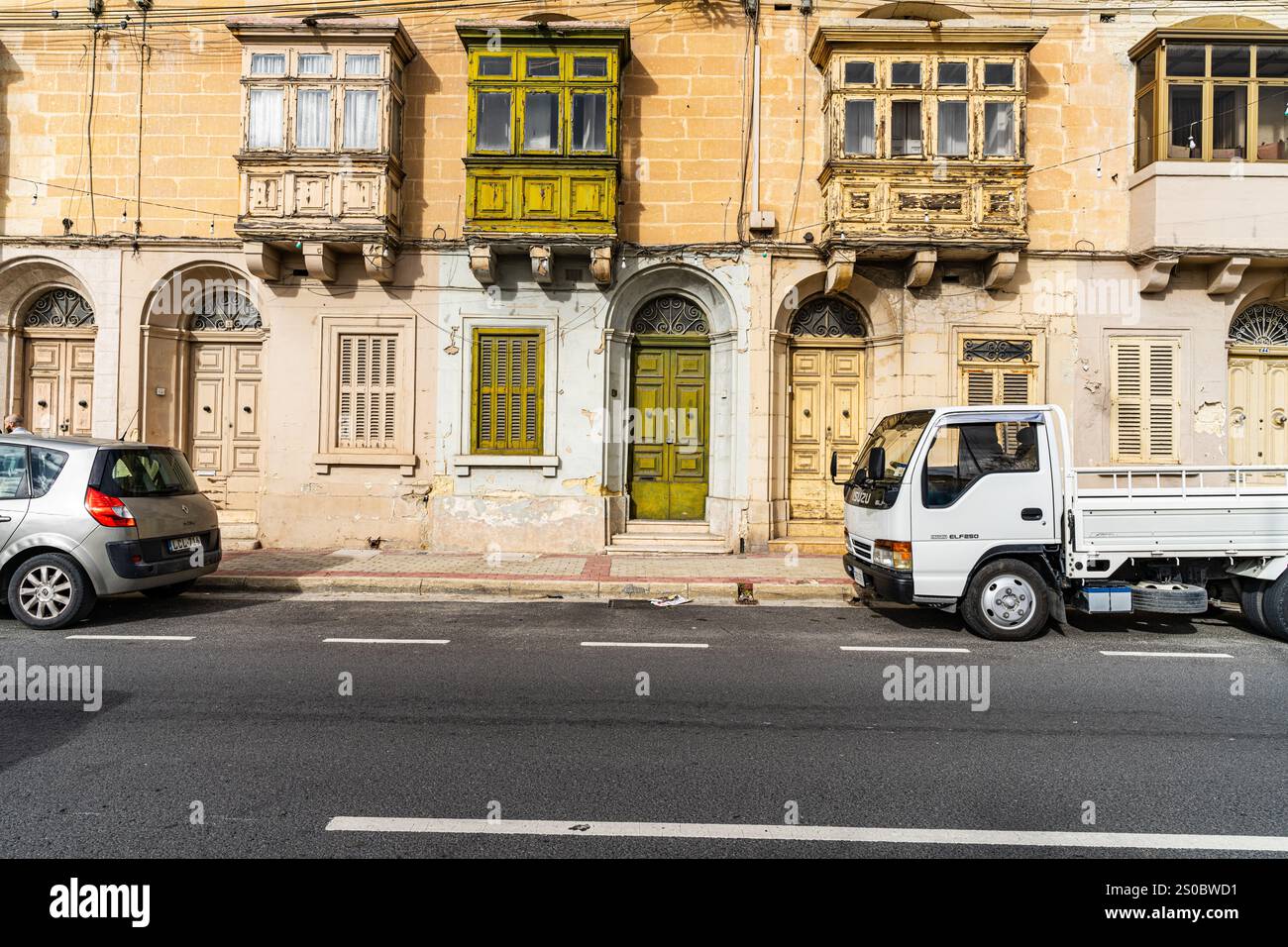 Traditional house detail in Malta. Limestone yellow bricks and colorful ...