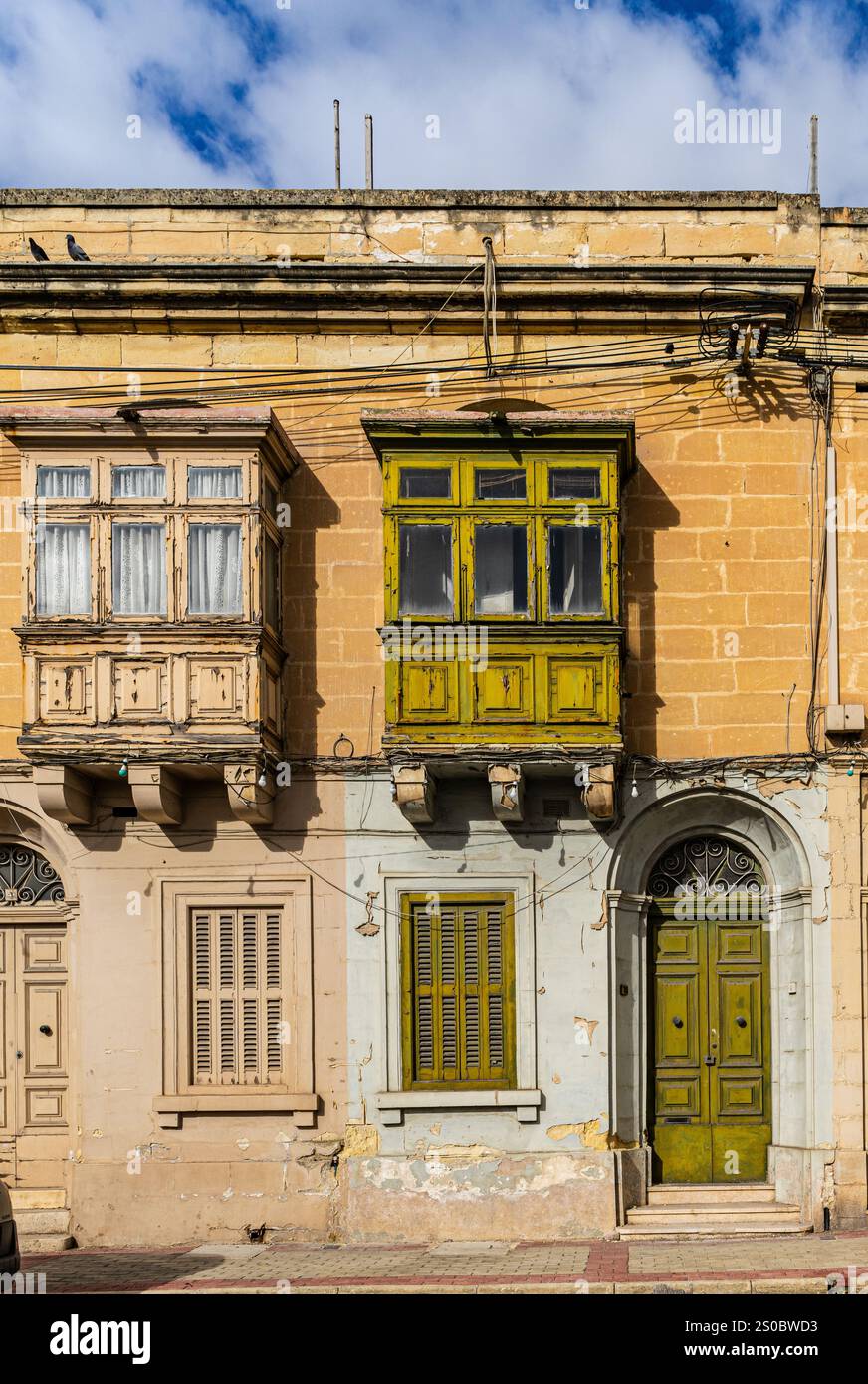 Traditional house detail in Malta. Limestone yellow bricks and colorful ...