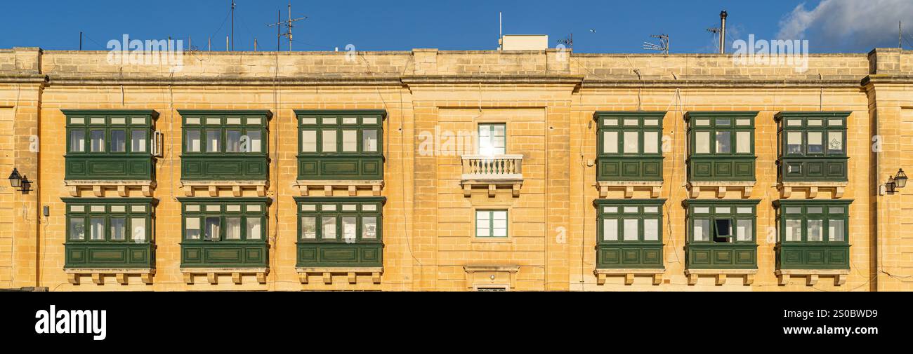 Traditional house detail in Malta. Limestone yellow bricks and colorful ...