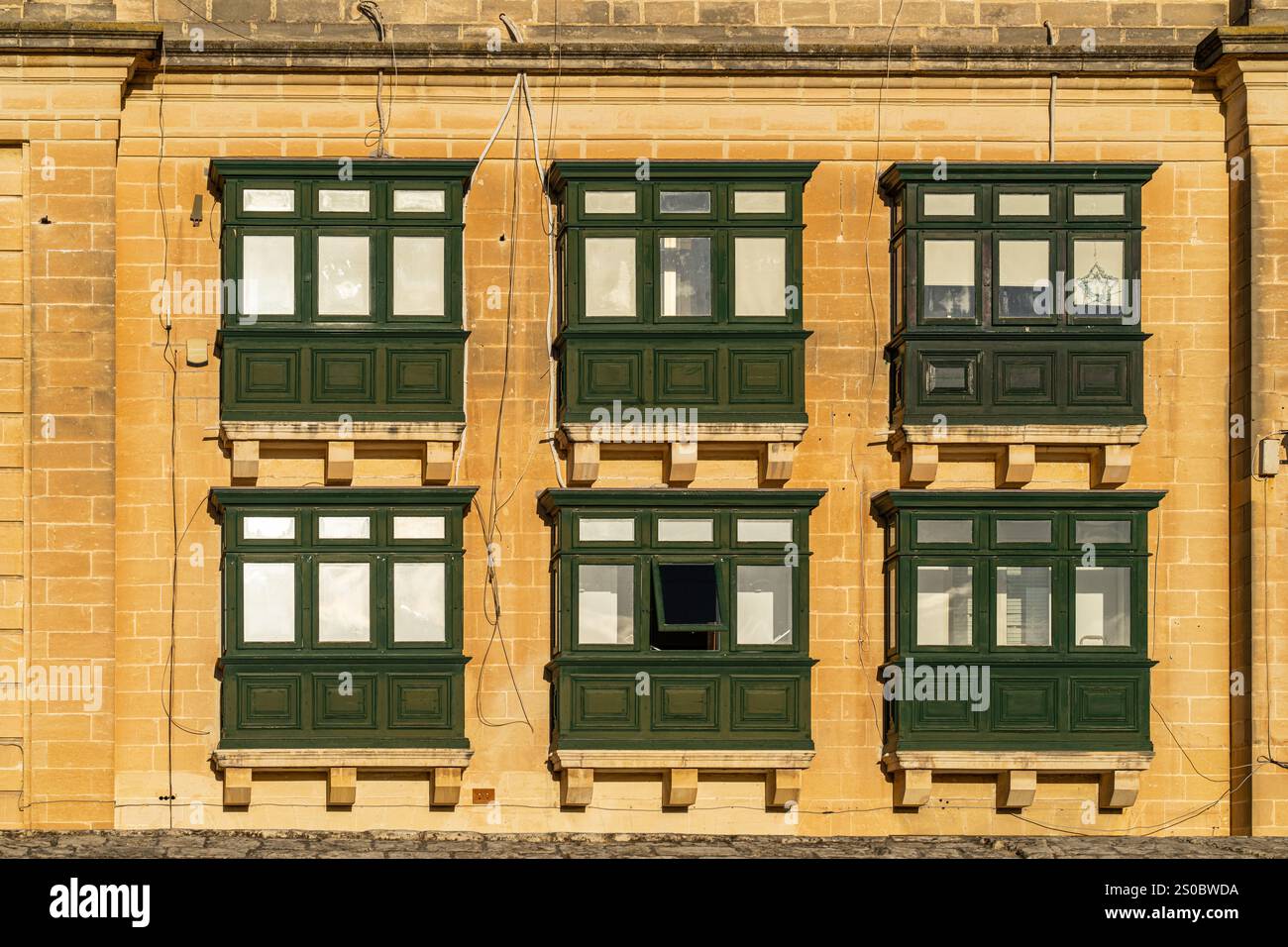 Traditional house detail in Malta. Limestone yellow bricks and colorful ...
