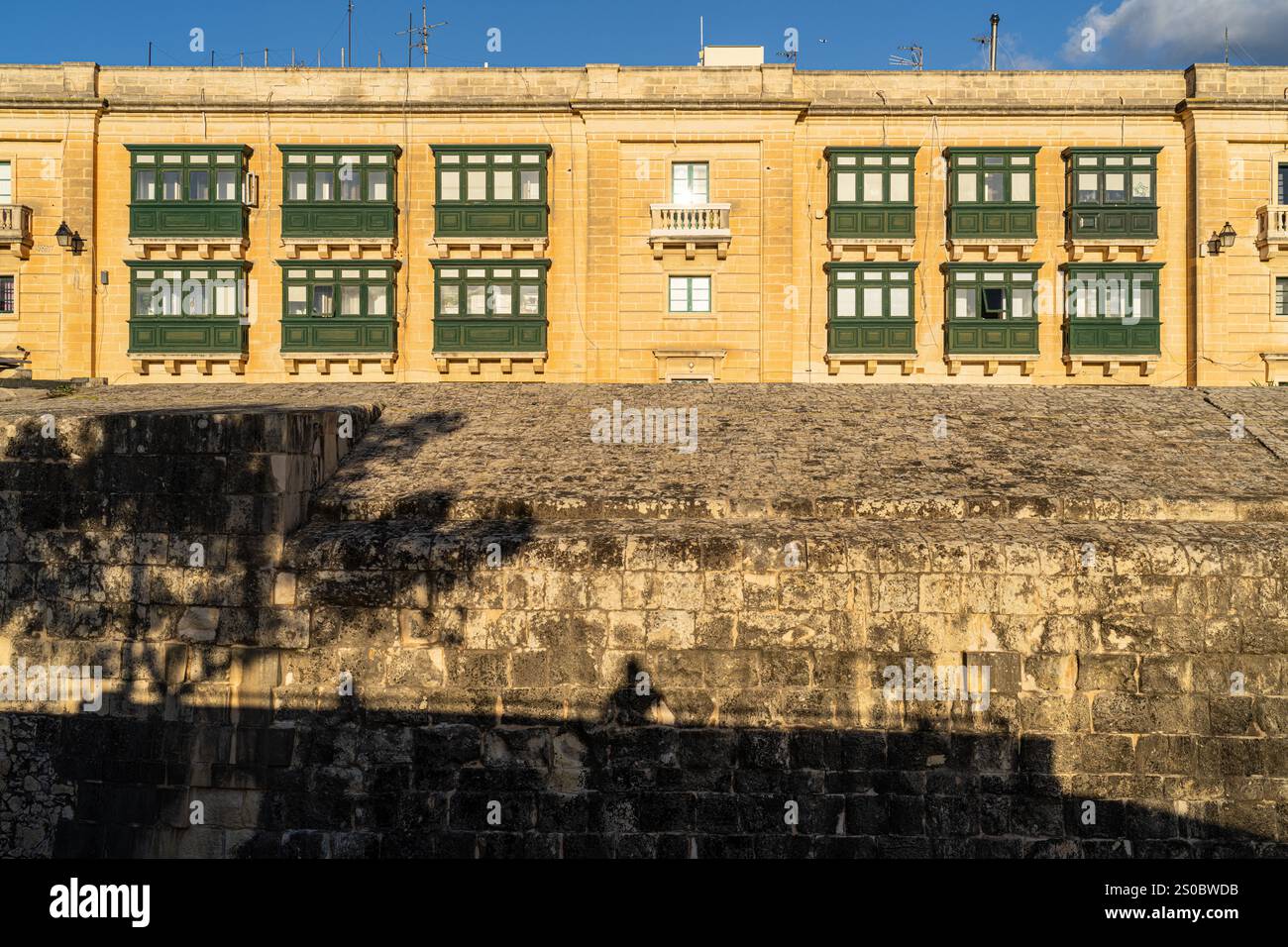 Traditional house detail in Malta. Limestone yellow bricks and colorful ...
