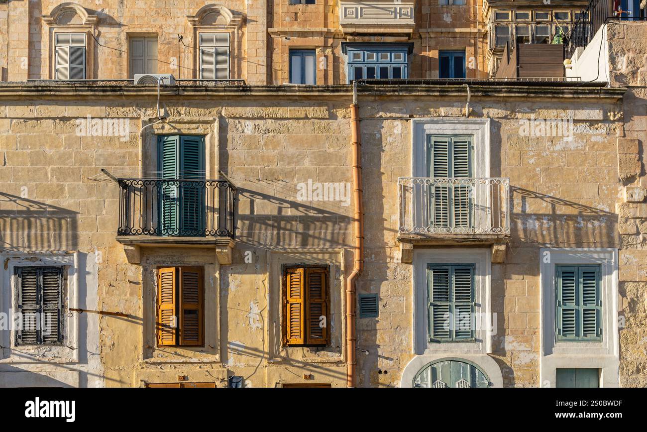 Traditional house detail in Malta. Limestone yellow bricks and colorful ...