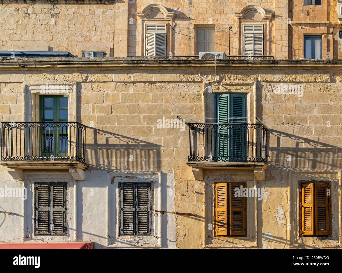 Traditional house detail in Malta. Limestone yellow bricks and colorful ...