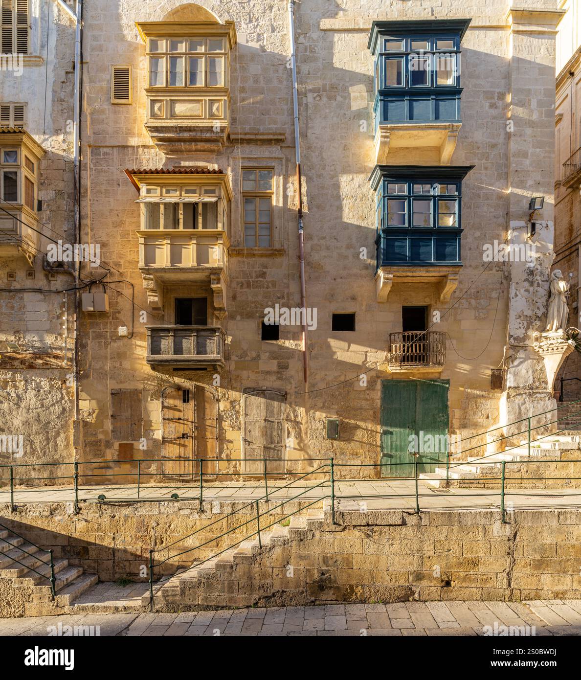 Traditional house detail in Malta. Limestone yellow bricks and colorful ...