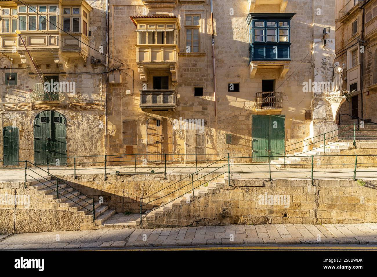 Traditional house detail in Malta. Limestone yellow bricks and colorful ...